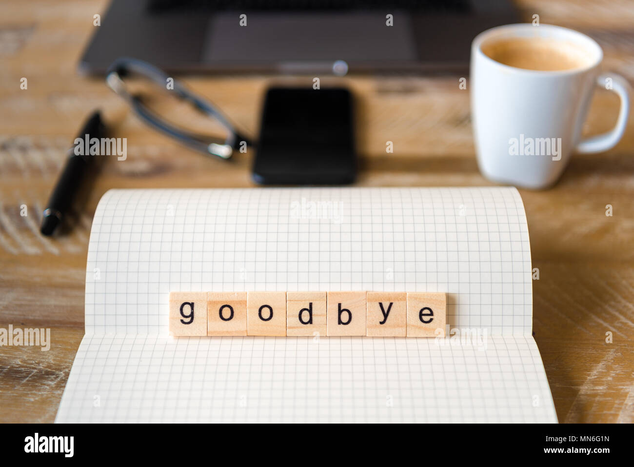Closeup on notebook over wood table background, focus on wooden blocks ...