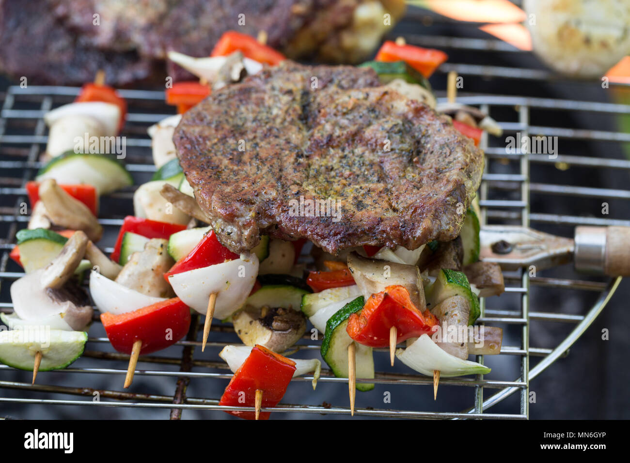 barbecue with delicious grilled meat and vegetables on grill Stock ...