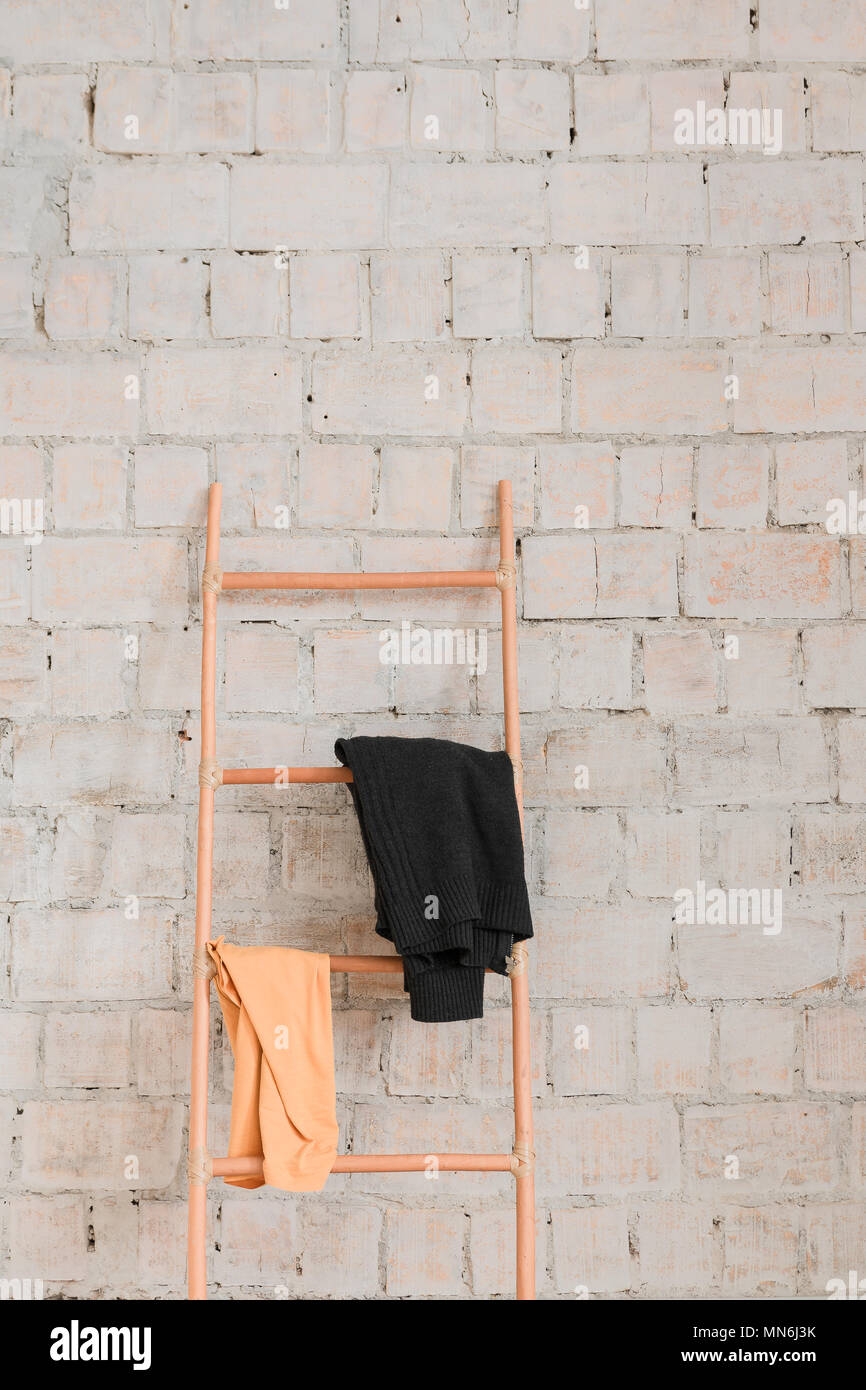 Ladder for clothes in a loft style of wood Stock Photo - Alamy
