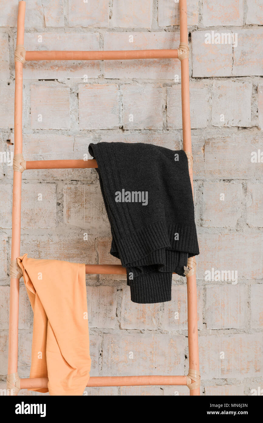 Ladder for clothes in a loft style of wood Stock Photo - Alamy