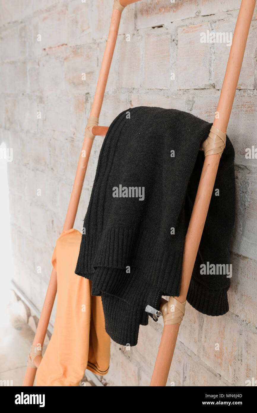 Ladder for clothes in a loft style of wood Stock Photo - Alamy