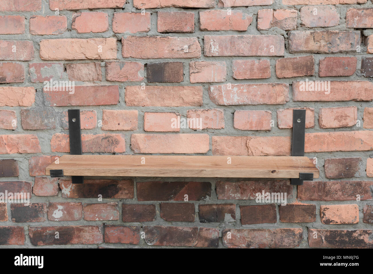 Shelf in wood and metal hanging on a brick wall in loft style Stock ...