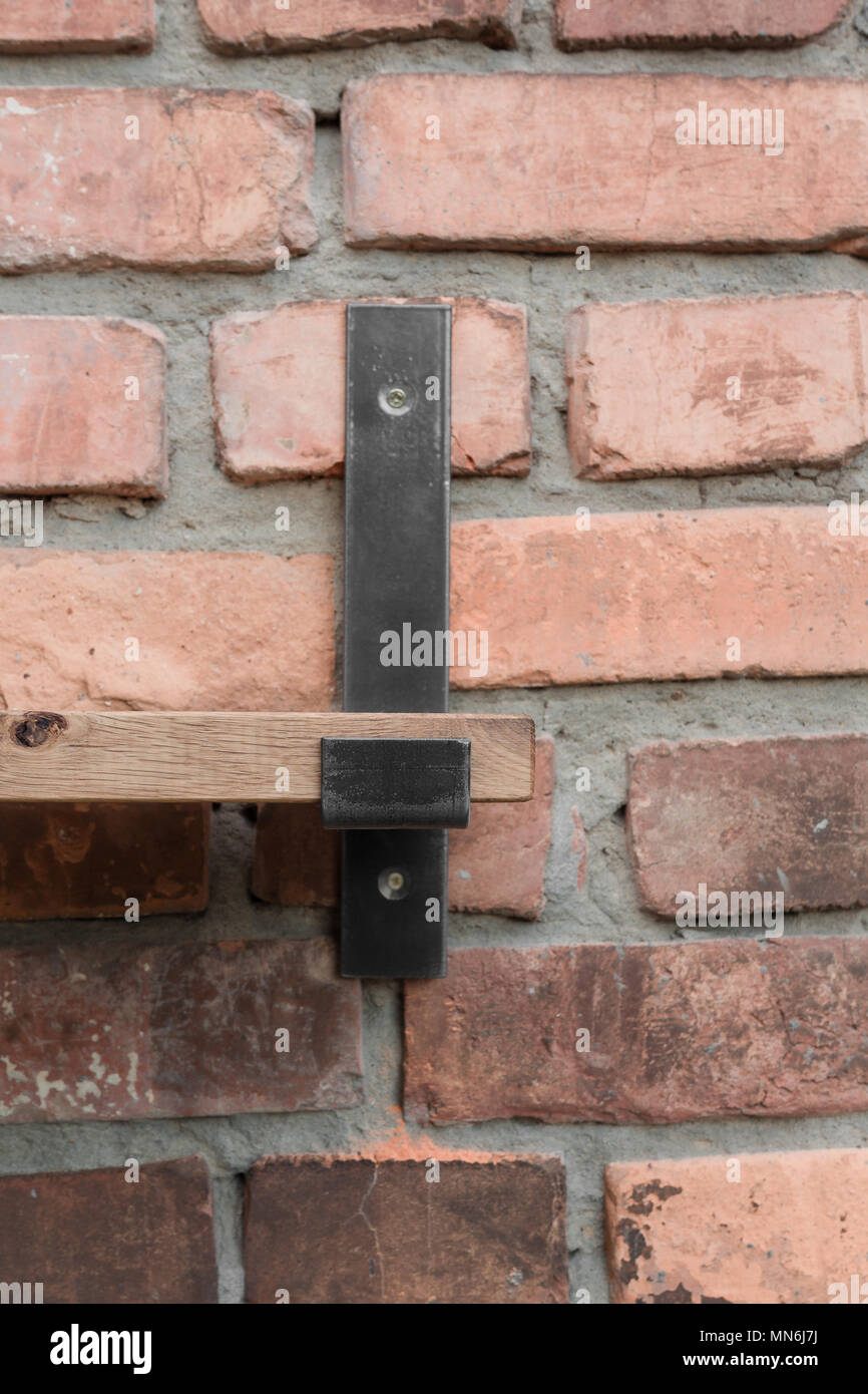 Shelf in wood and metal hanging on a brick wall in loft style Stock ...