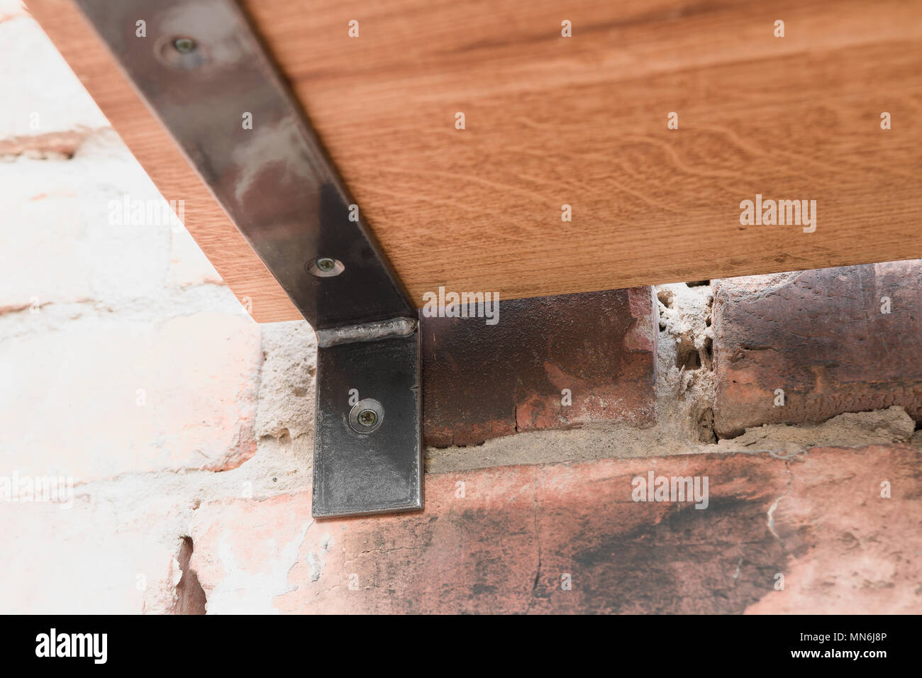 Shelf in wood and metal hanging on a brick wall in loft style Stock ...