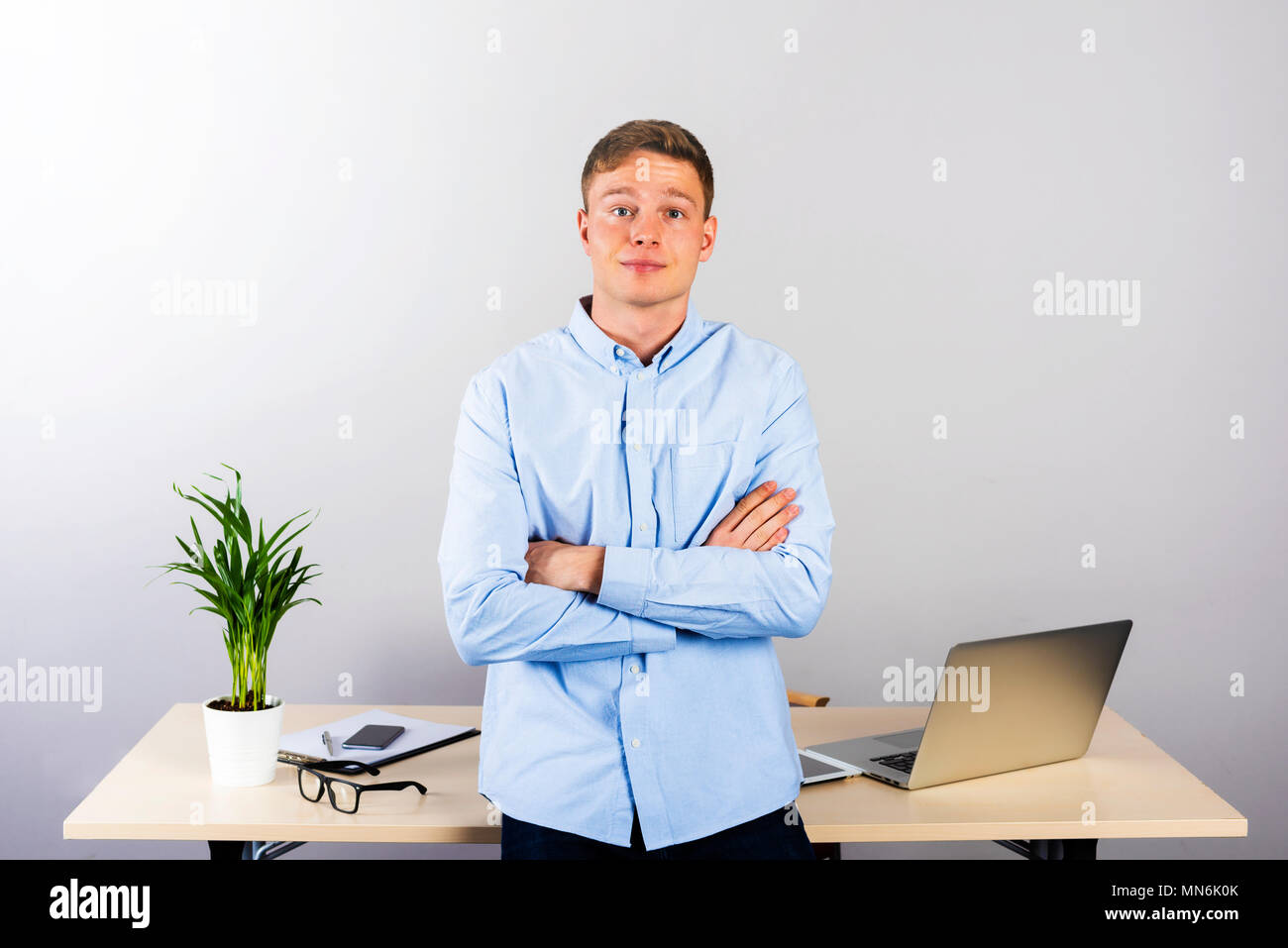 Office man standing by desk Stock Photo - Alamy