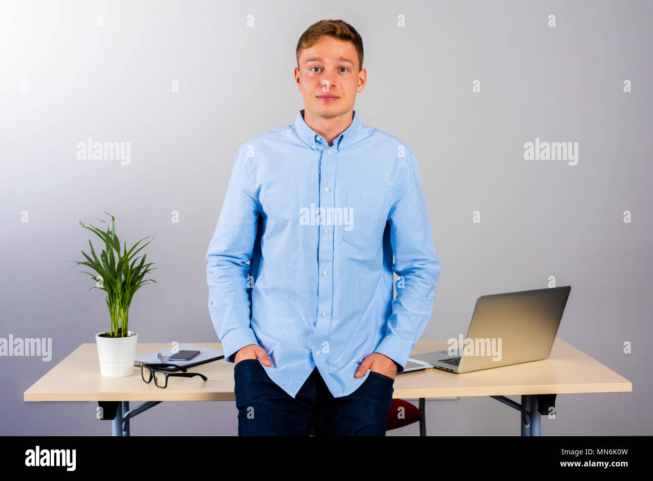 Office man standing by desk Stock Photo - Alamy
