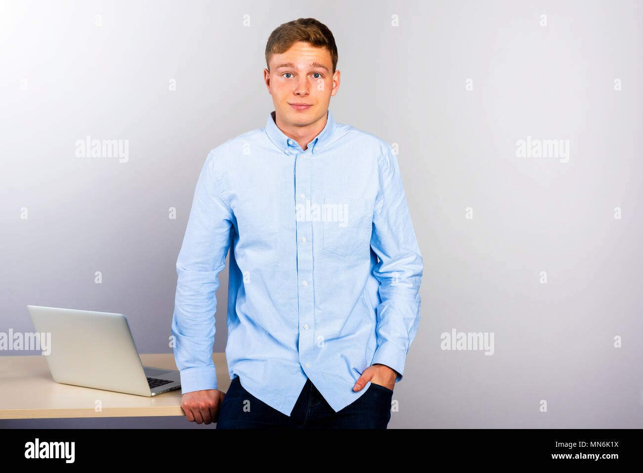 Man by the desk in office Stock Photo - Alamy