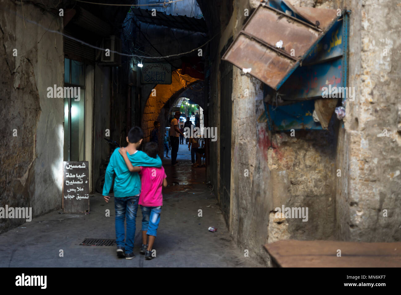 Two lebanese boys hugging and walking through the souks of Tripoli ...