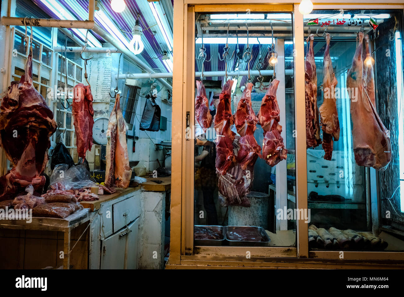 Butcher shop window with hanged pieces of meat at the souk of old Amman ...
