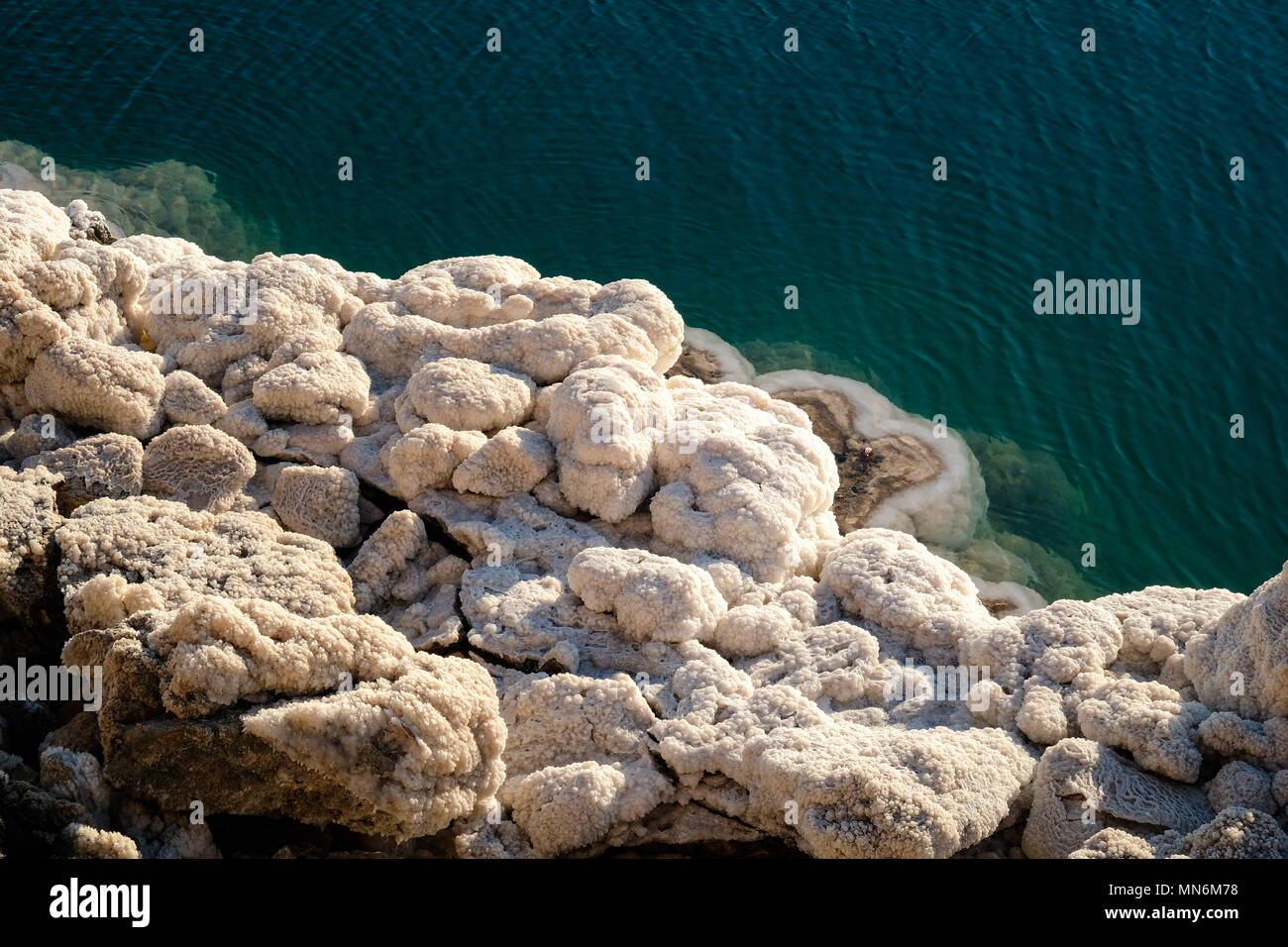 Blue water and rock salt on Dead sea shore Stock Photo - Alamy