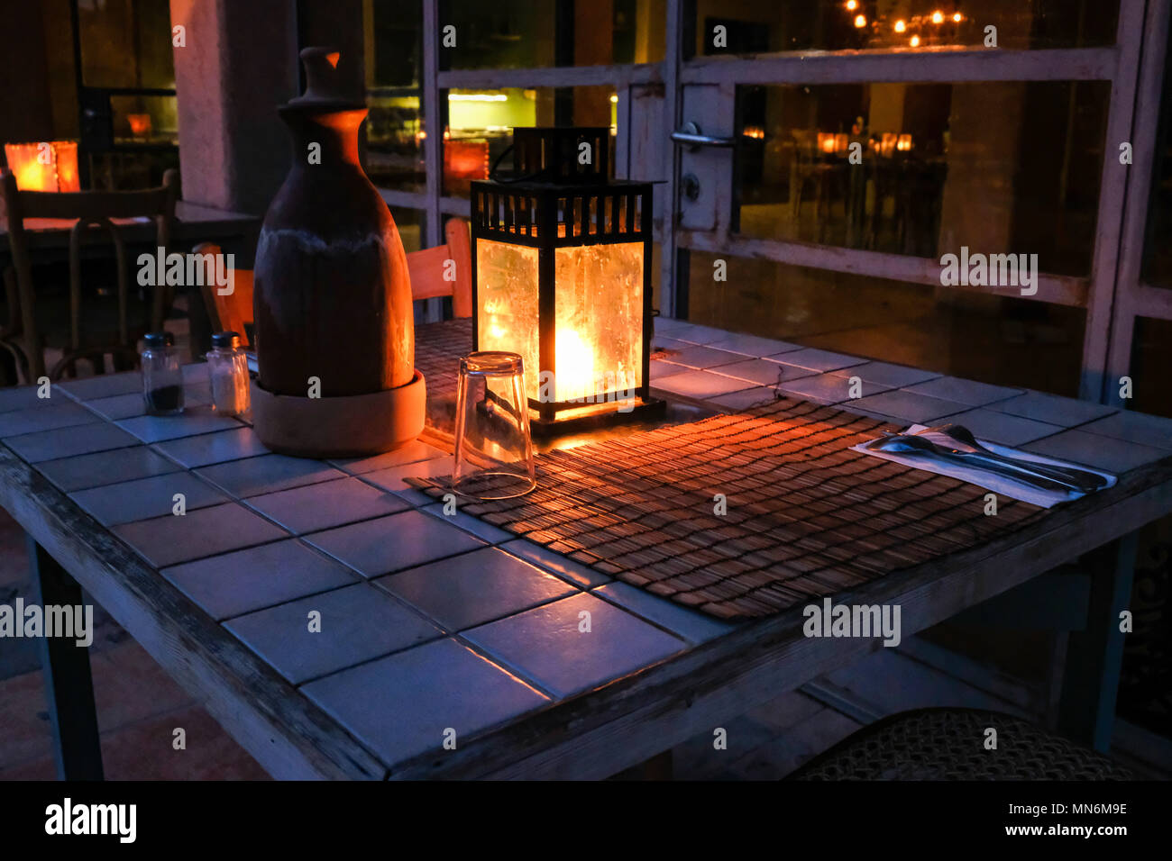 Restaurant table lightened by candle Stock Photo - Alamy