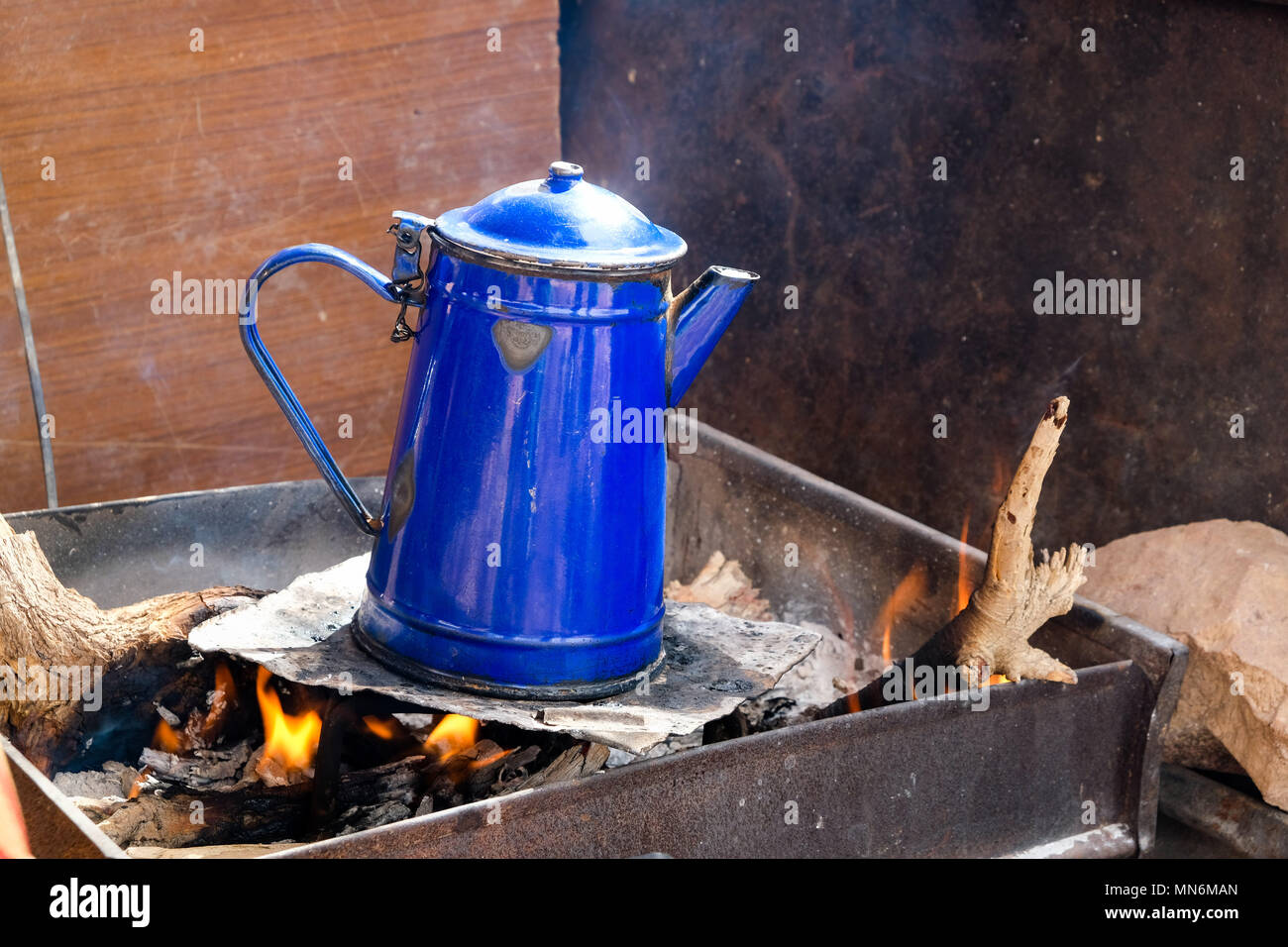 Fresh coffee being prepared in a blue cafetiere on the fire Stock Photo ...