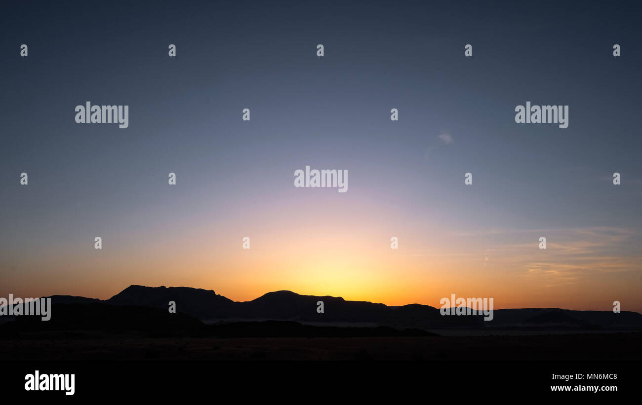 Sunset in the desert with sandstone background Stock Photo - Alamy