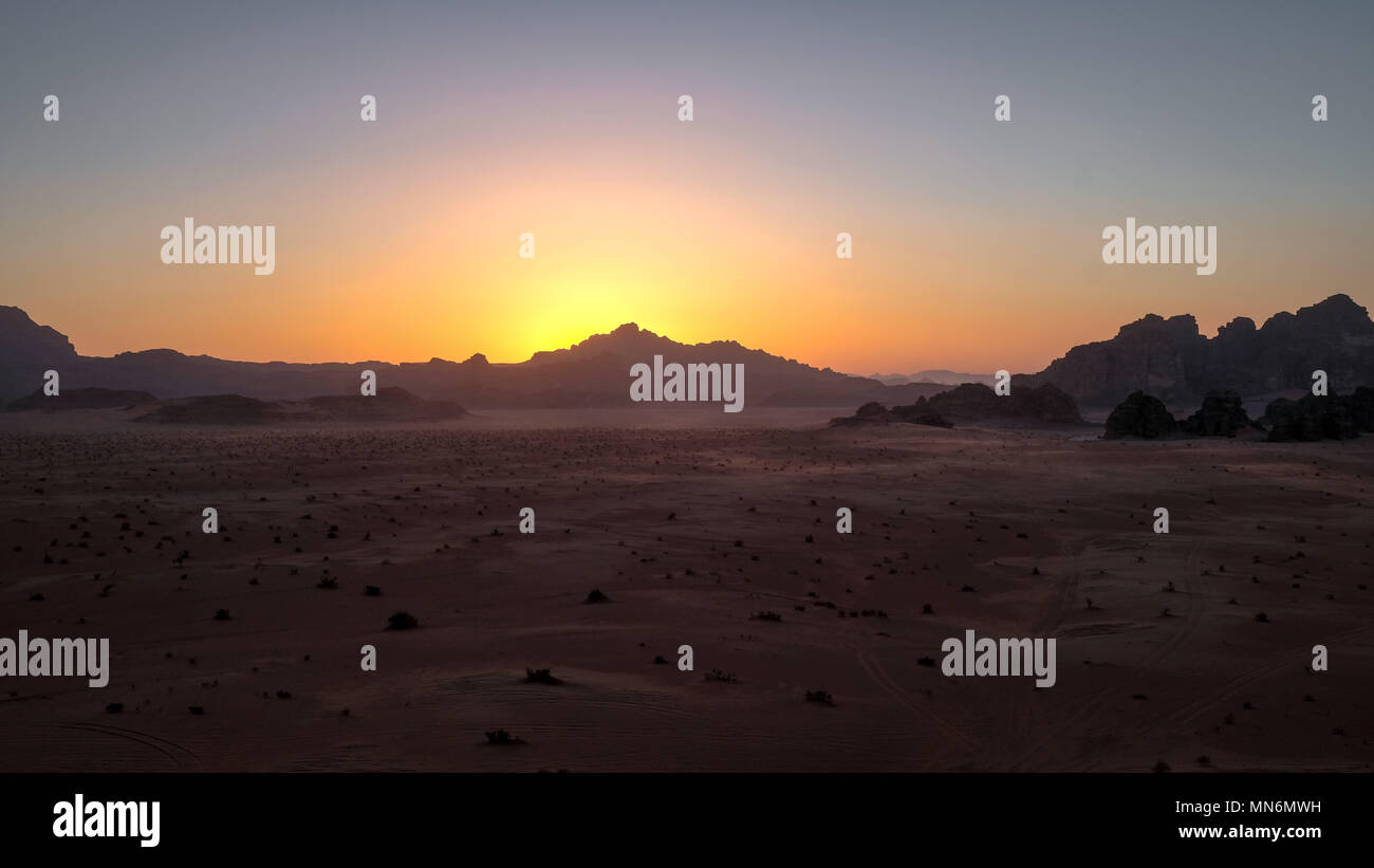 Sunset in the desert with sandstone background Stock Photo - Alamy