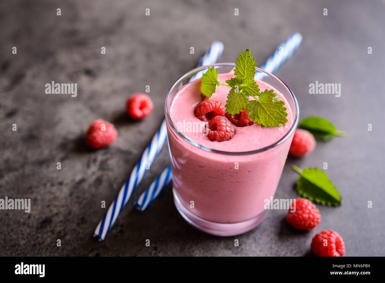 Glass of refreshing raspberry milkshake for breakfast Stock Photo - Alamy