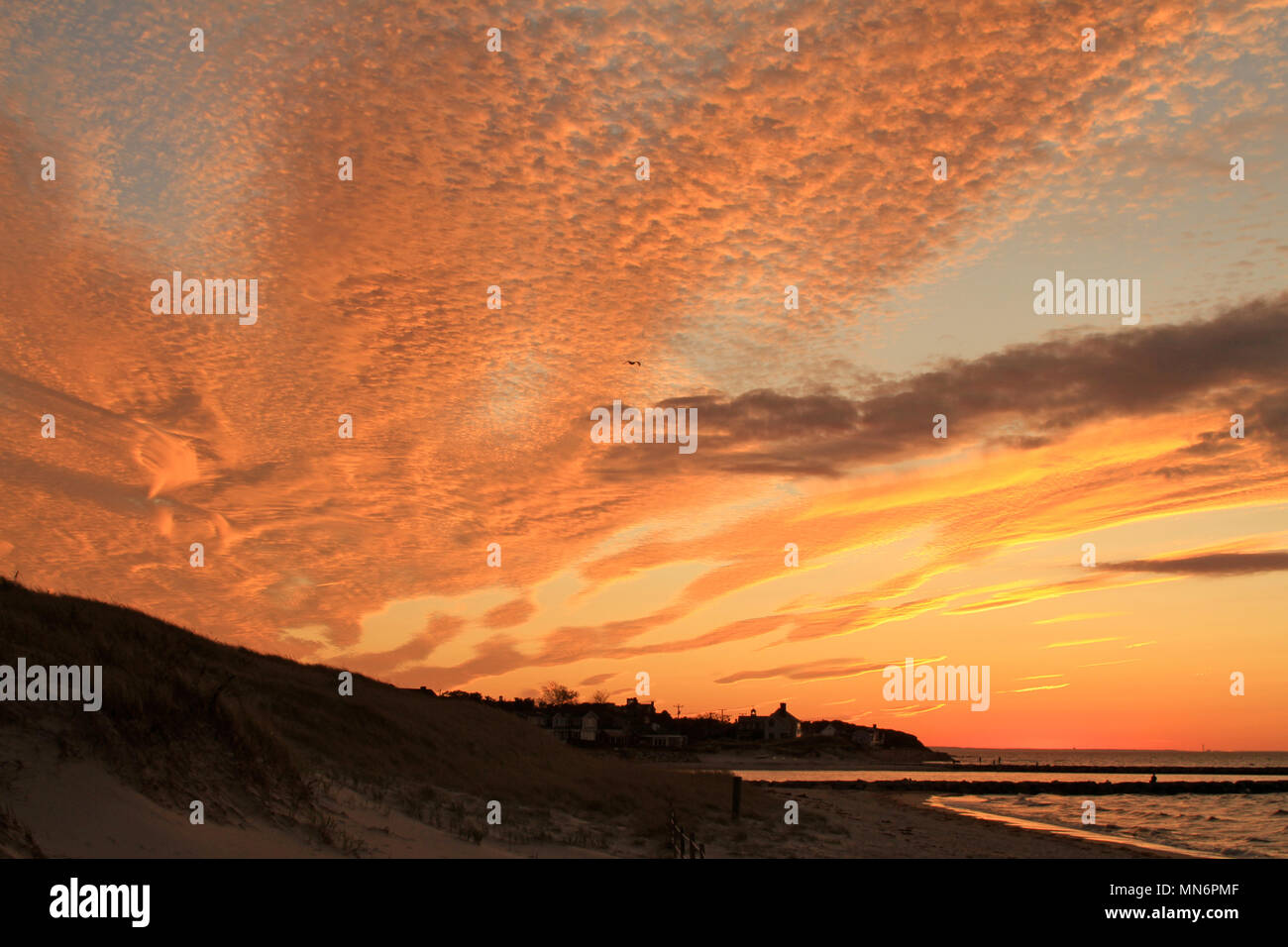 A beautiful orange glow sunset on Cape Cod Bay at Cold Storage Beach ...