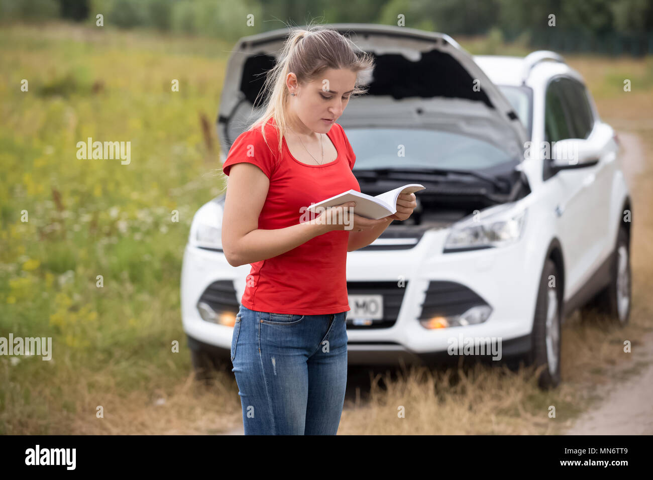 Portrait fo young woman got stuck on countryside road because of her ...