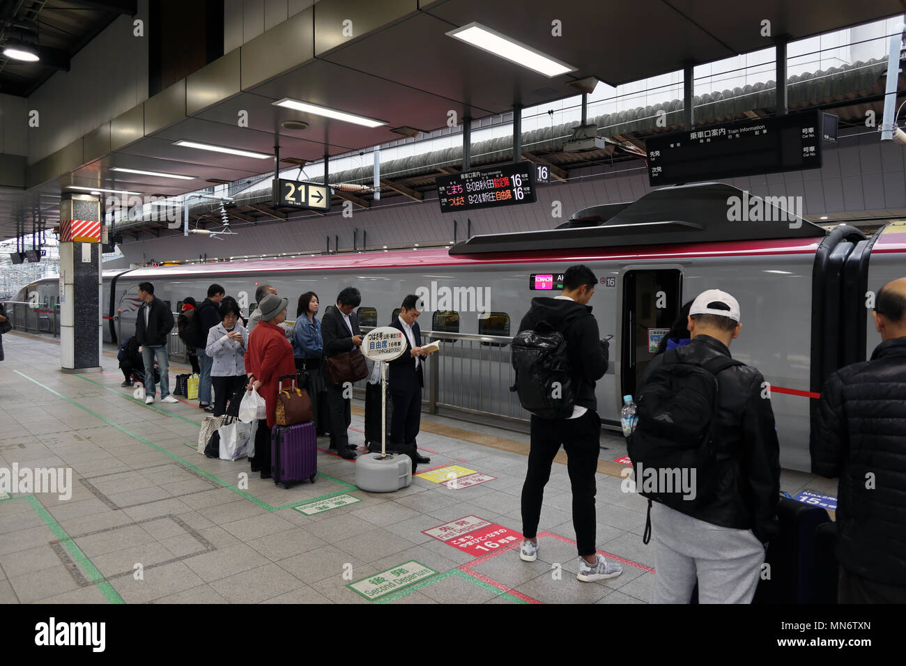 Passengers wait in line to board Akita Shinkansen at Tokyo Station, Japan Stock Photo - Alamy