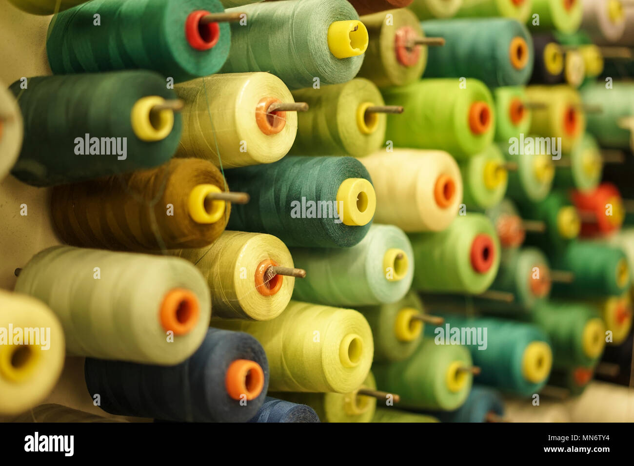 Collection of green threads on spools Stock Photo - Alamy