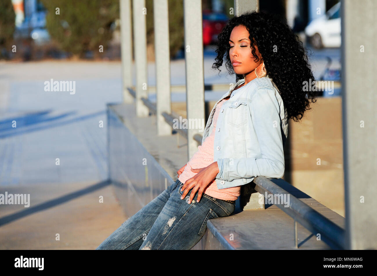 Portrait of a young black woman, model of fashion in urban background ...
