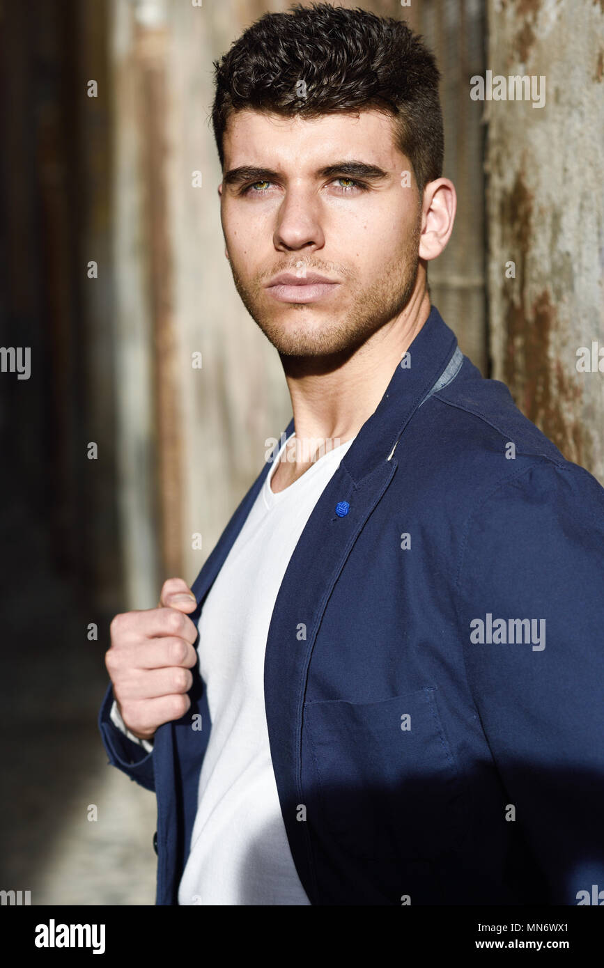 Good looking young man with blue eyes in the street. Model of fashion ...