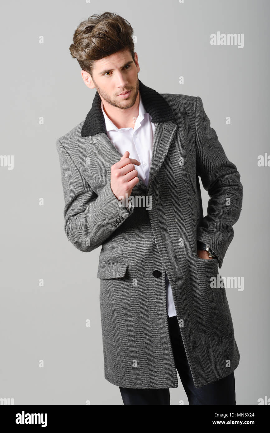 Portrait of handsome man, model of fashion, wearing coat. Studio shot ...
