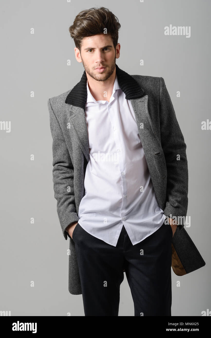Portrait of handsome man, model of fashion, wearing coat. Studio shot ...