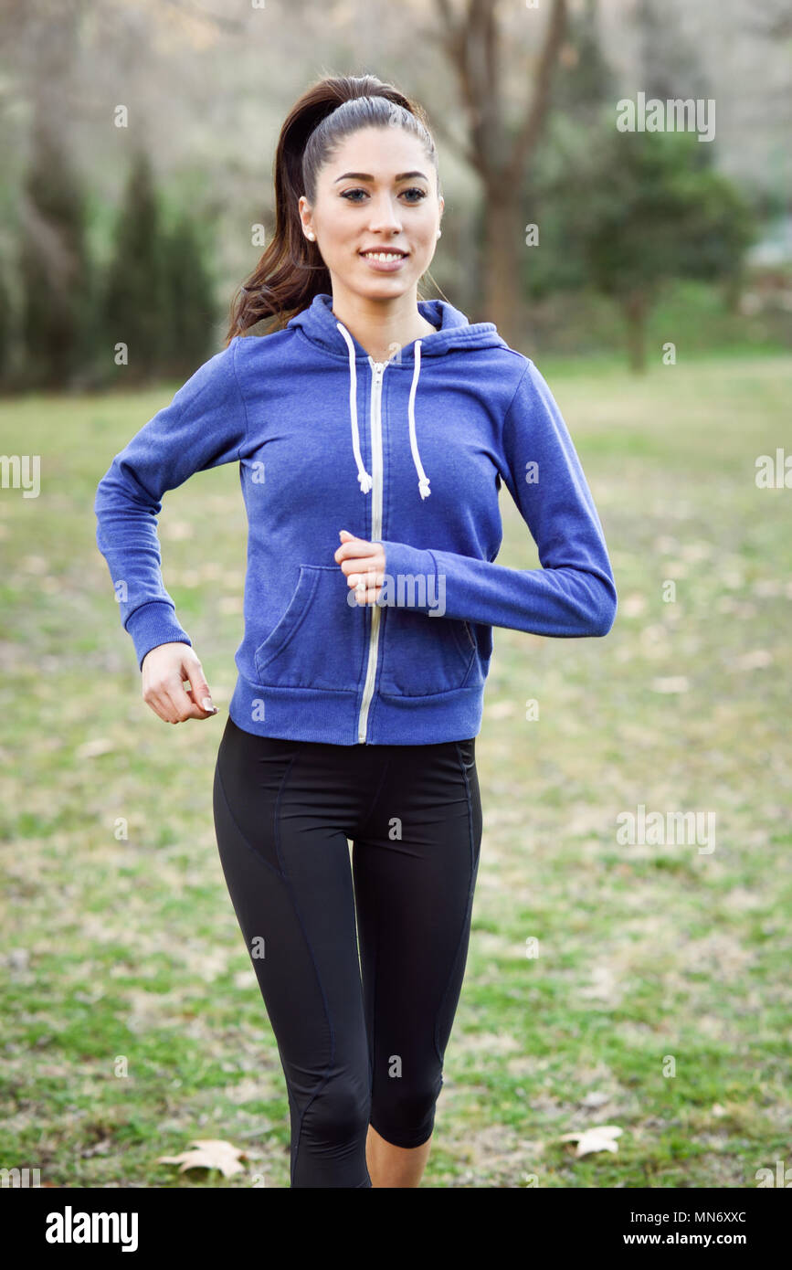 Running woman. Female Runner Jogging during Outdoor Workout in a Park ...