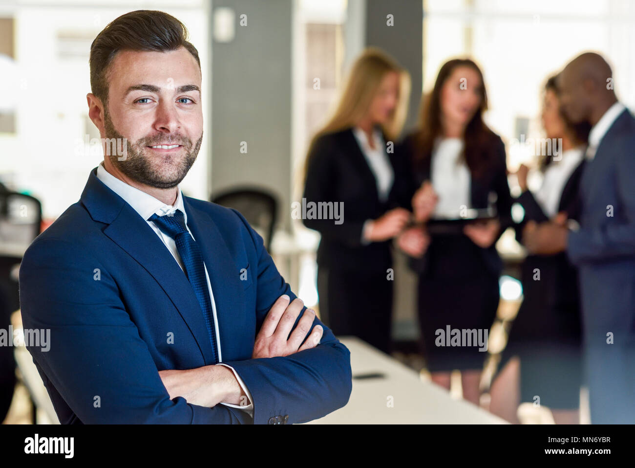 Caucasian businessman leader looking at camera in modern office with ...