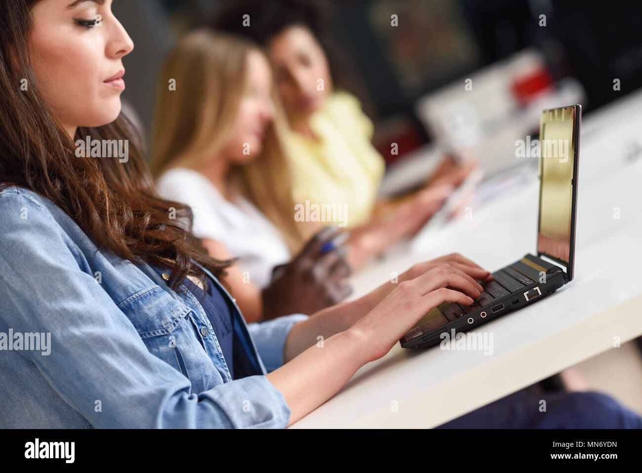 Young woman studying with laptop computer on white desk. Beautiful ...