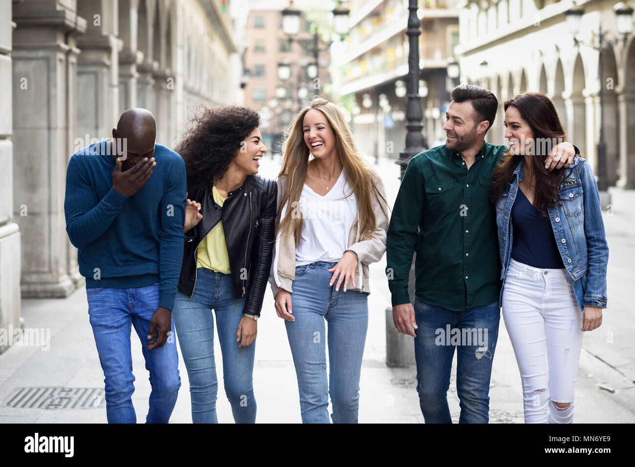 Multi-ethnic group of young people having fun together outdoors in ...