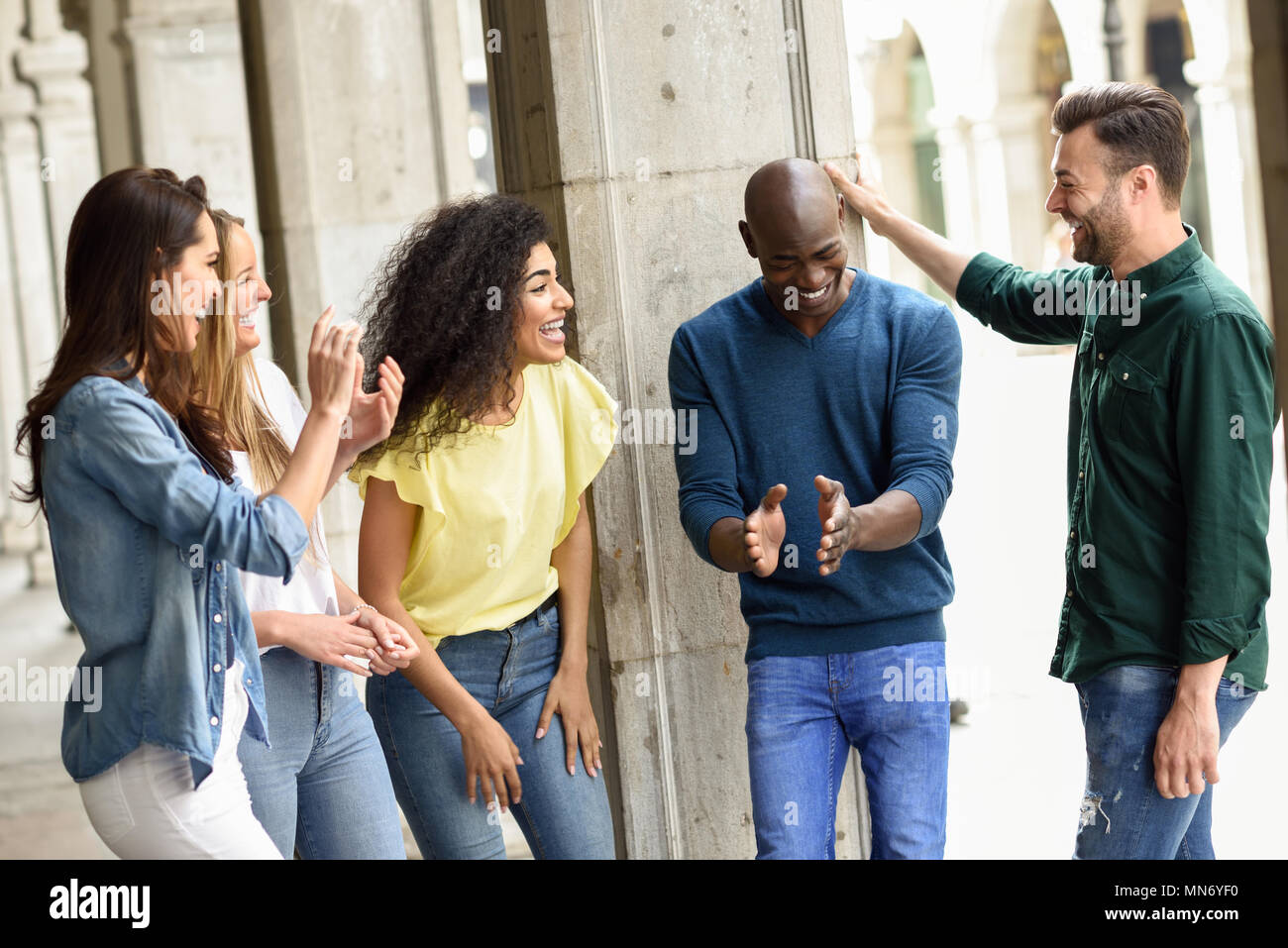 Multi-ethnic group of young people having fun together outdoors in ...