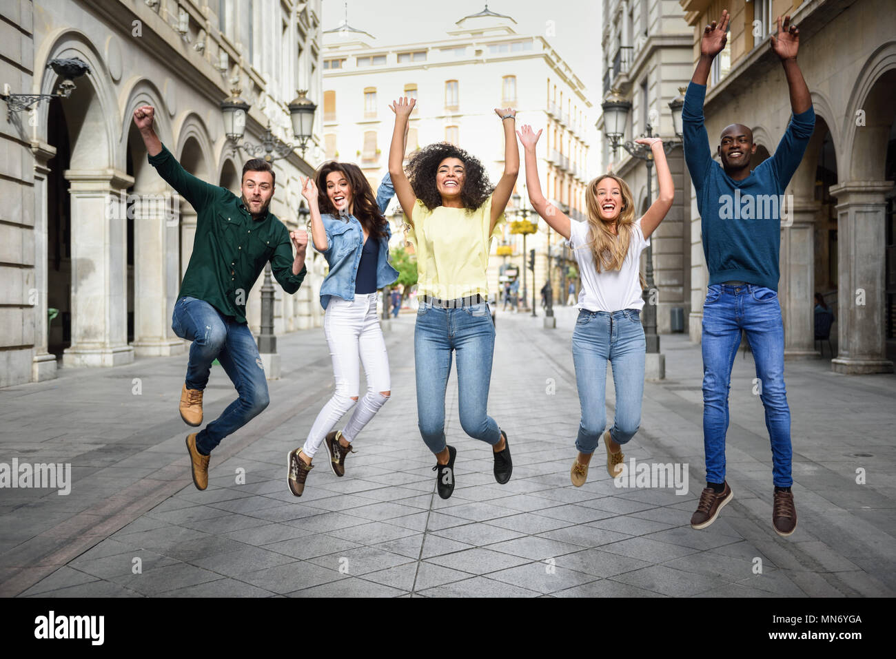 Multi-ethnic group of young people having fun together outdoors in ...