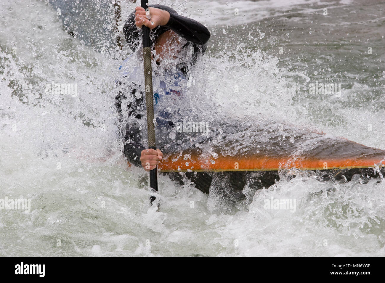 A canoeist paddling through fast running white water Stock Photo - Alamy