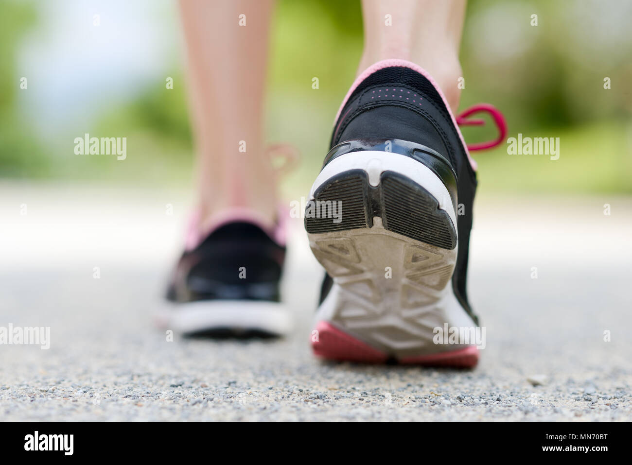Woman feet running on road closeup on shoe Stock Photo - Alamy