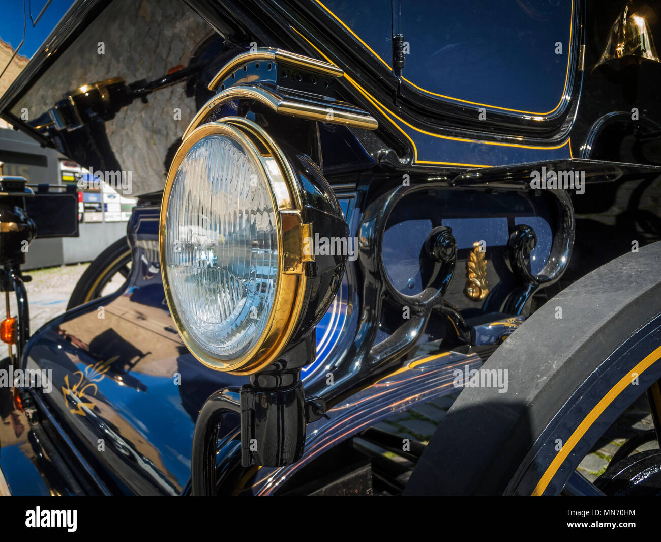 Detail view of the headlight of a replica motorized blue coach with ...