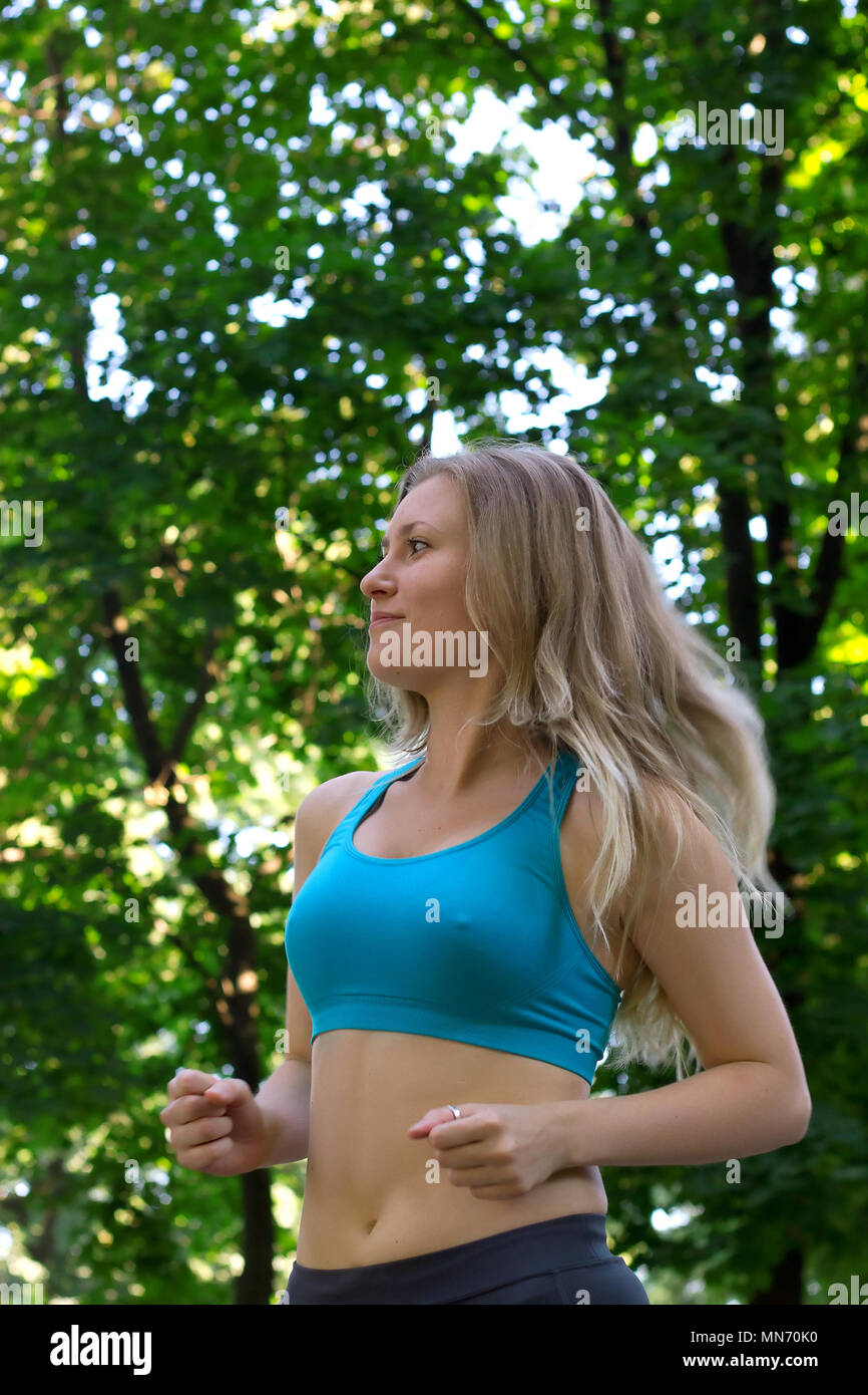 Girl running in the park along trees Stock Photo - Alamy