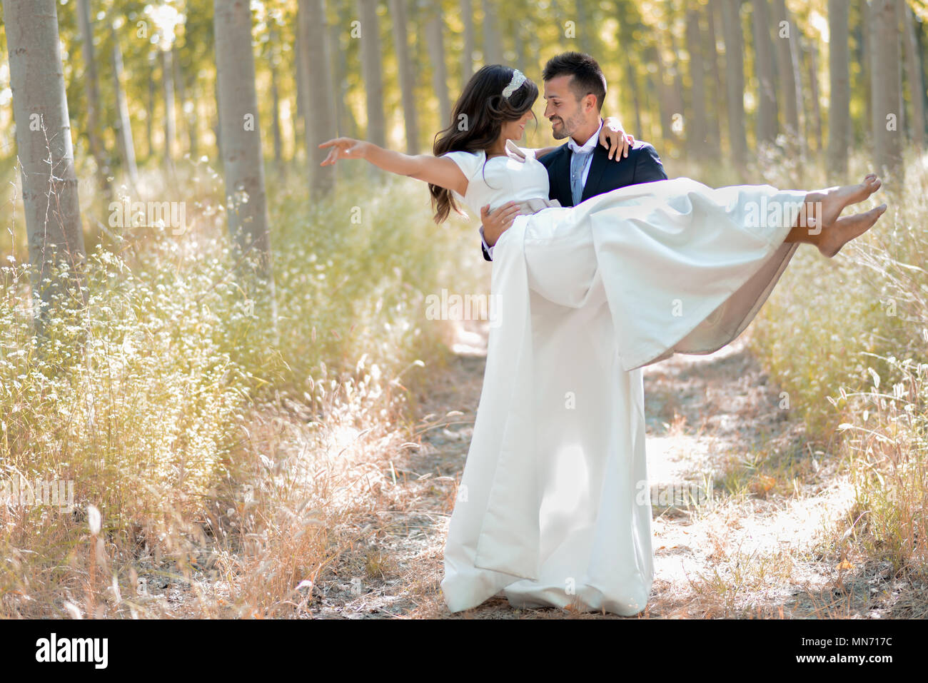 Just married couple together in poplar background Stock Photo - Alamy