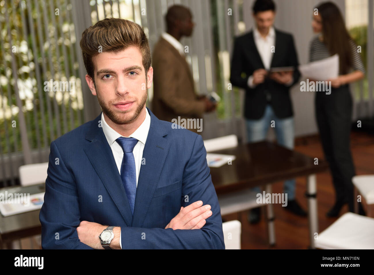 Image of male business leader looking at camera in working environment ...