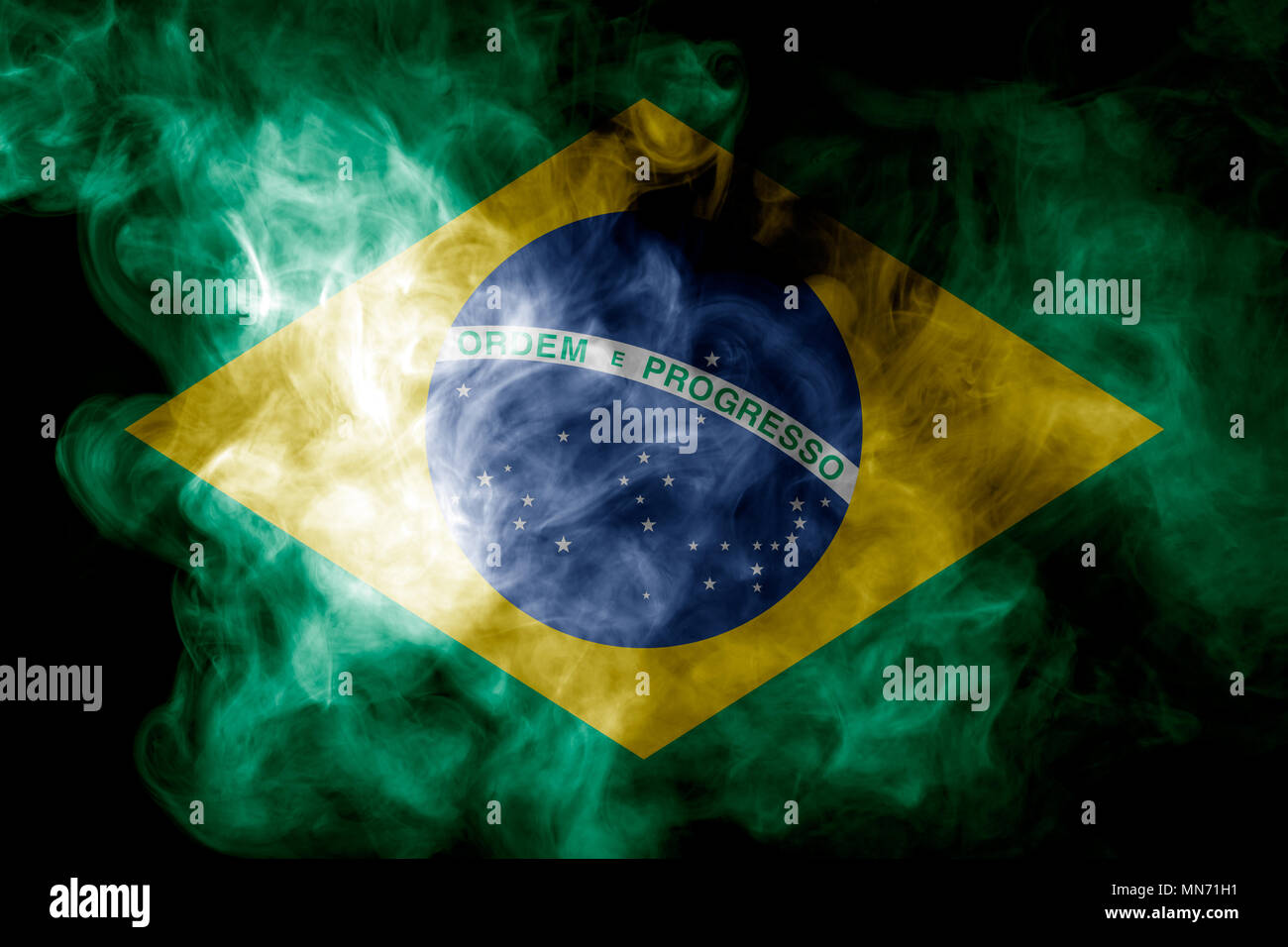 National flag of Brazil from thick colored smoke on a black isolated ...