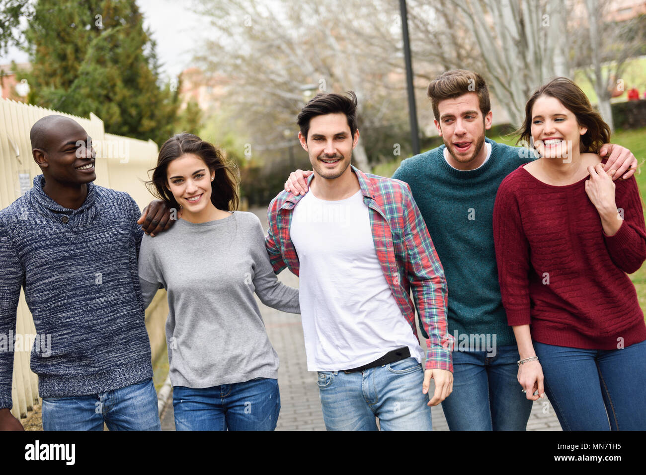 Group of multi-ethnic young people having fun together outdoors in ...