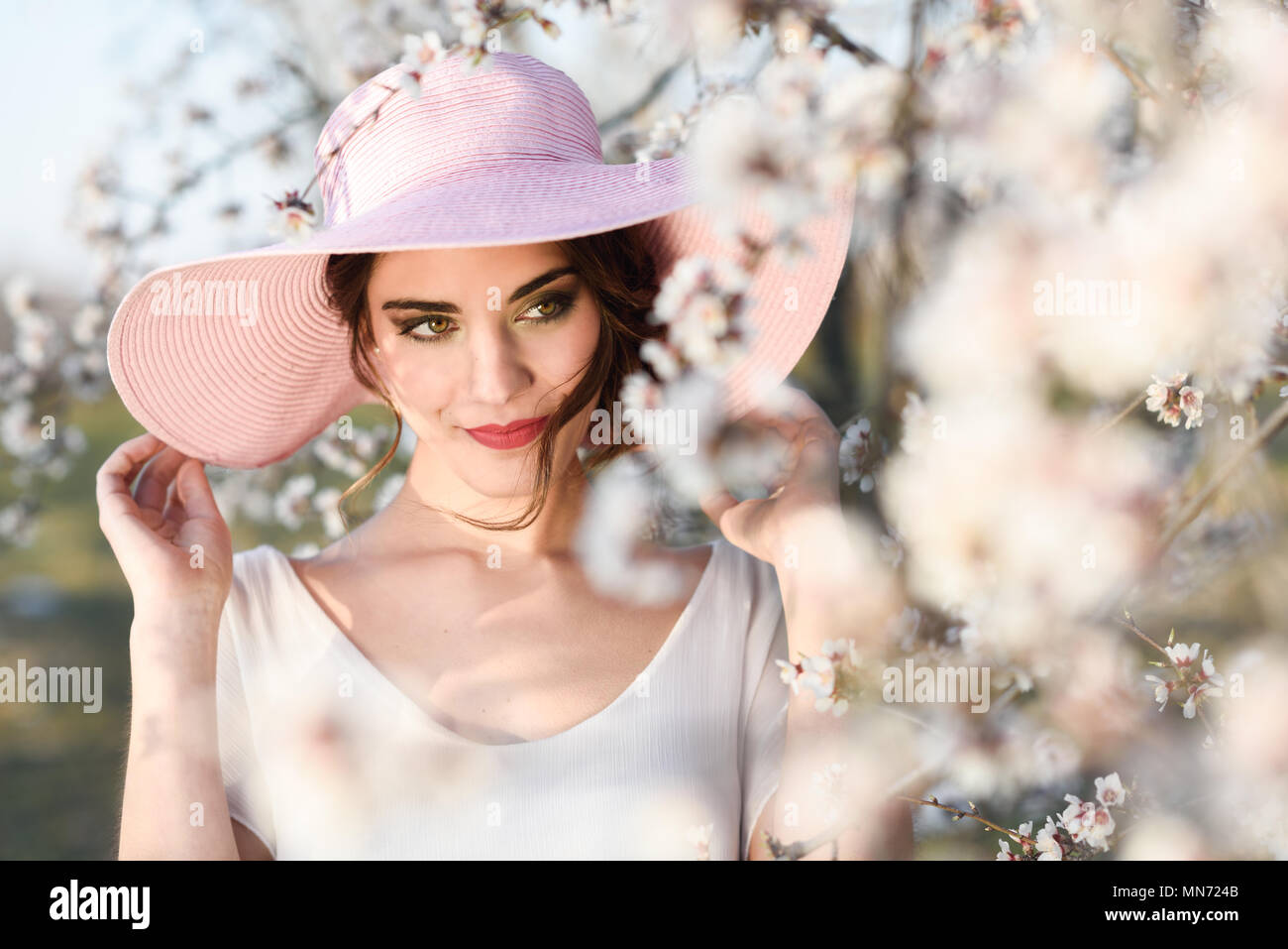 Woman wearing flowered hat hi-res stock photography and images - Alamy