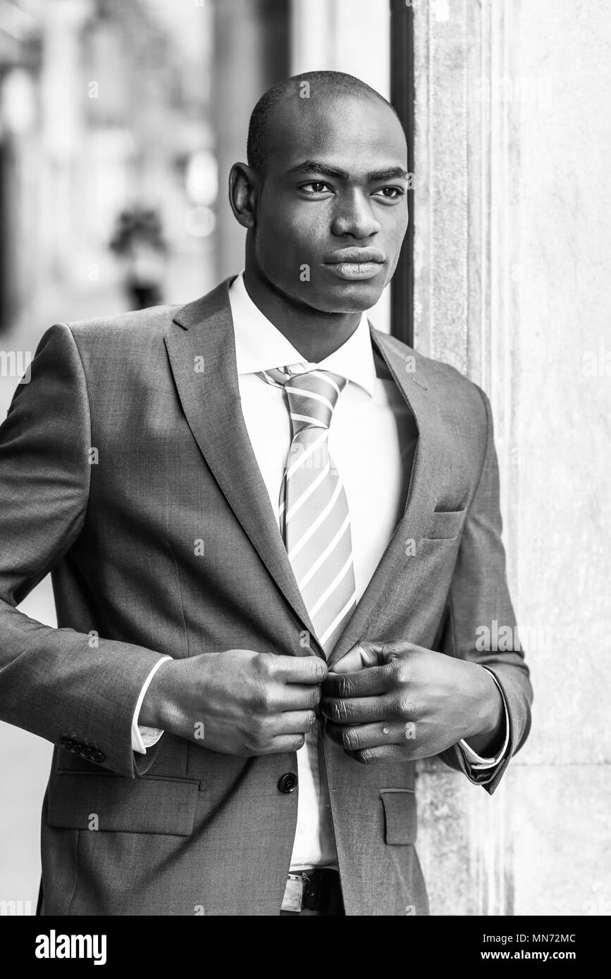 Portrait of handsome black man wearing suit in urban background Stock ...