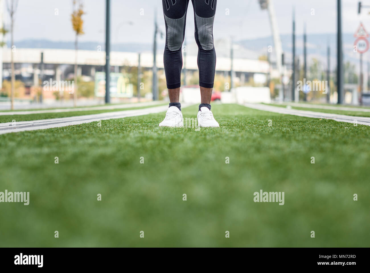 Feet of black man ready to running in urban background. Male doing ...