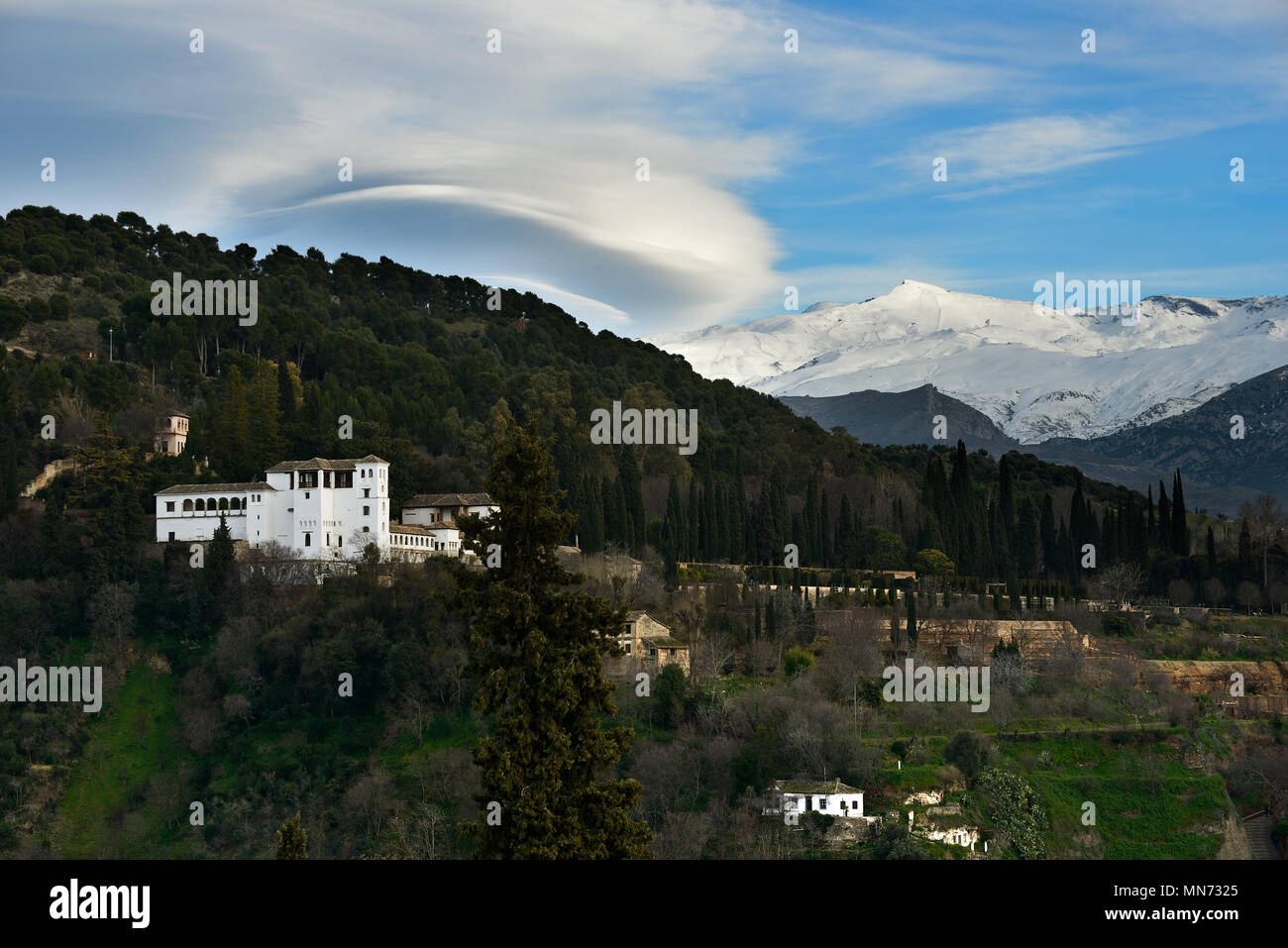 Aerial view of Alhambra and snowing Sierra Nevada mountains under a ...