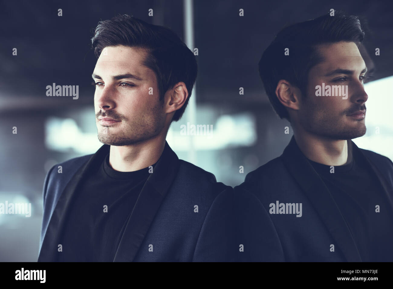 Portrait of an attractive man, model of fashion, wearing modern suit ...