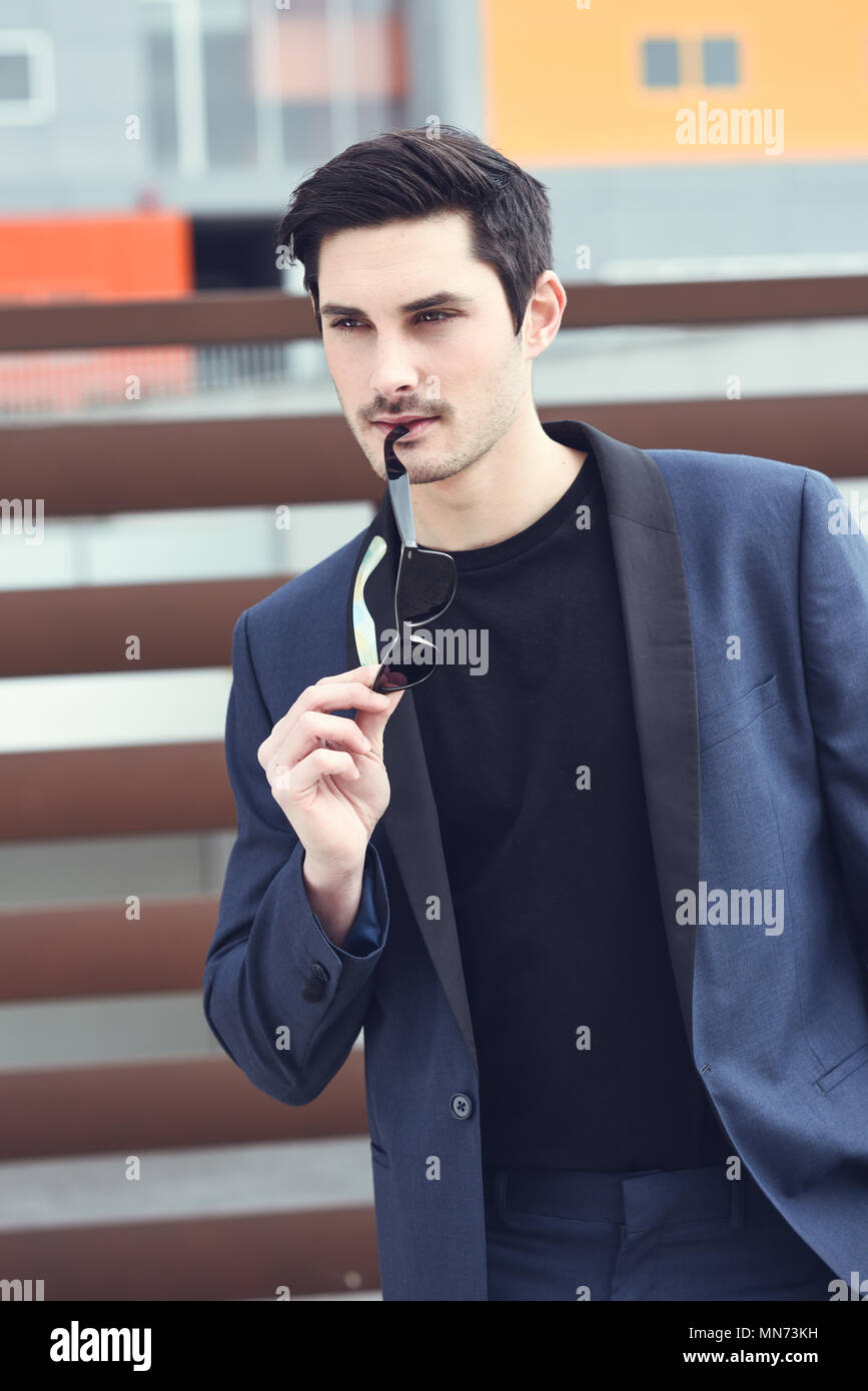 Portrait of an attractive man, model of fashion, wearing modern suit ...