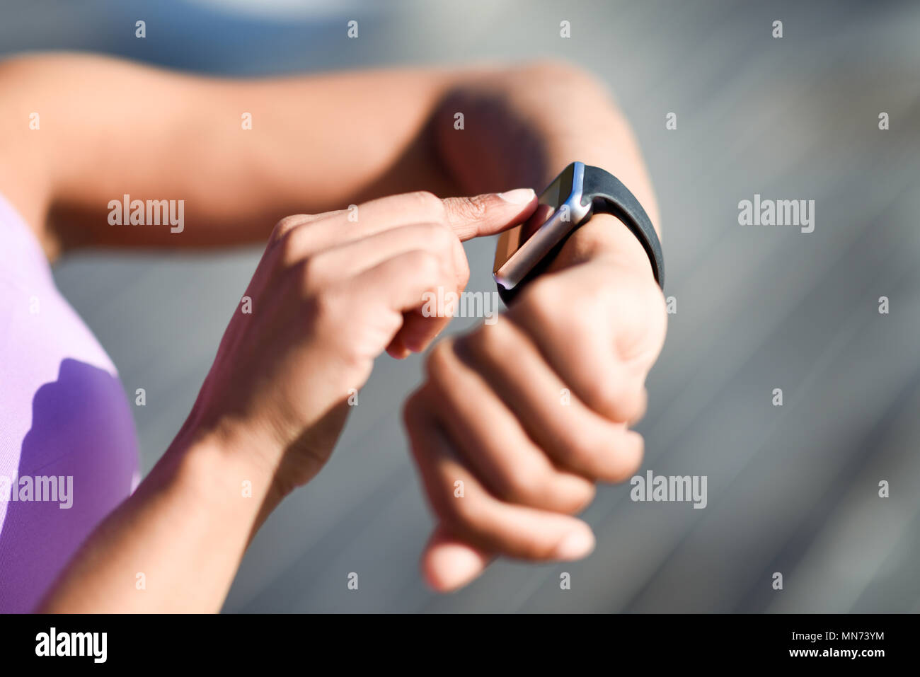 Woman using smartwatch touching touchscreen in active sports activity ...
