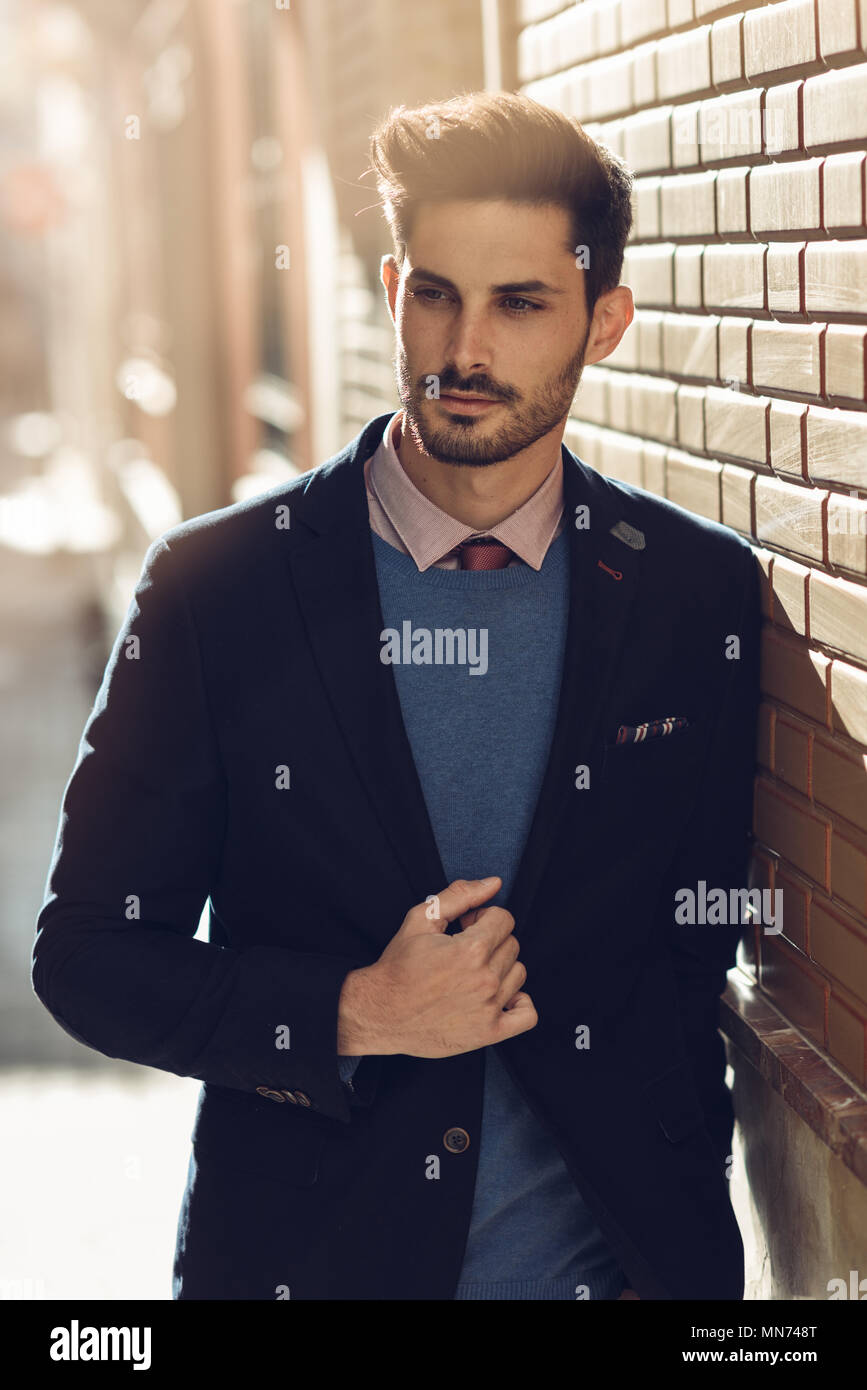 Attractive man in the street wearing british elegant suit. Young ...