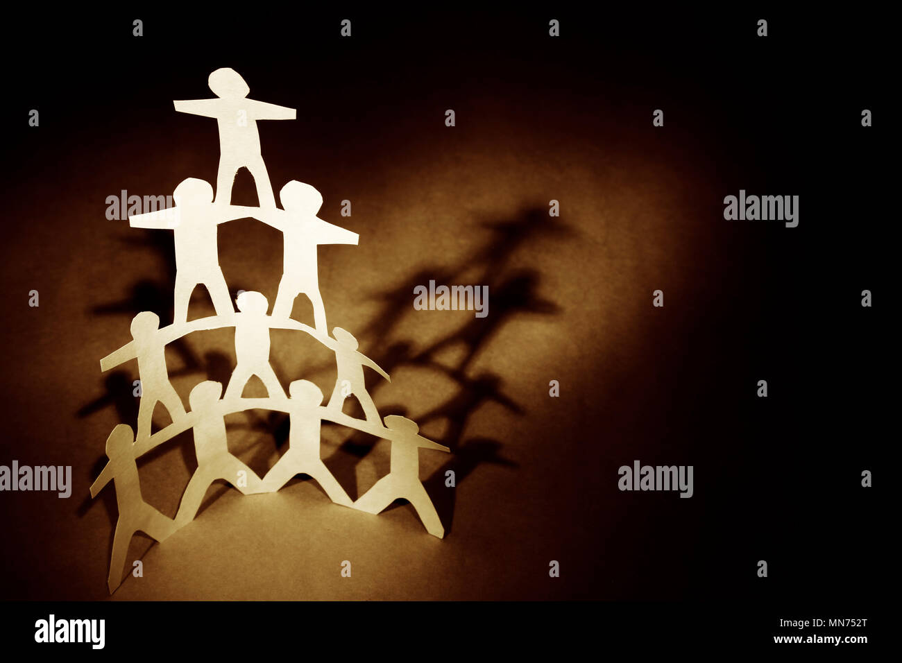 Human team pyramid supporting each other Stock Photo - Alamy